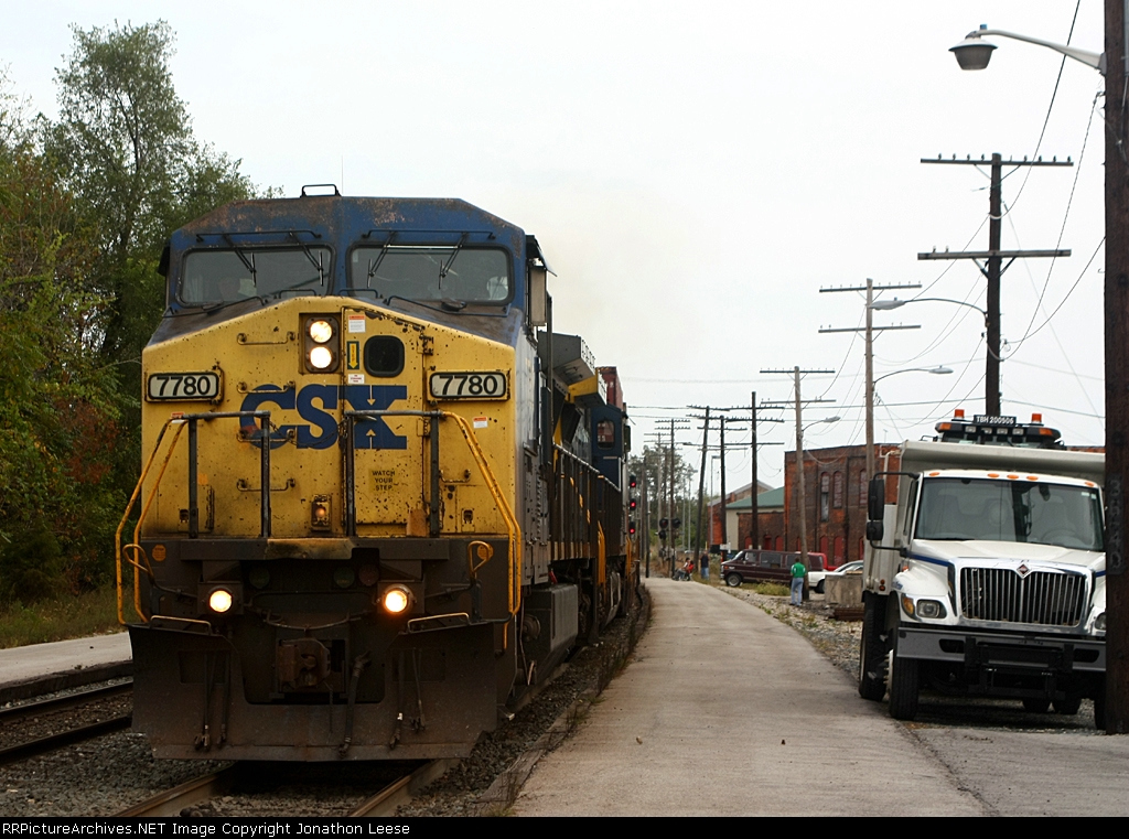 Q163 rolls past some railfans and parked CSX trucks